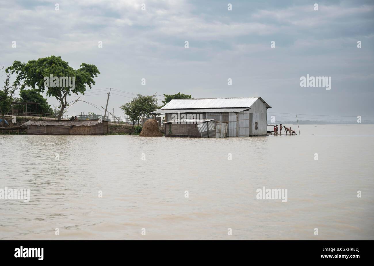 Morigaon, India. 4 July 2024. A settlement is partially submerged in ...