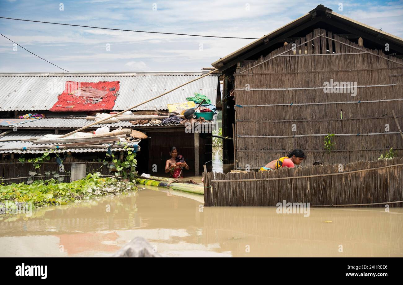 Morigaon, India. 4 July 2024. Residents in their flooded house, in a ...