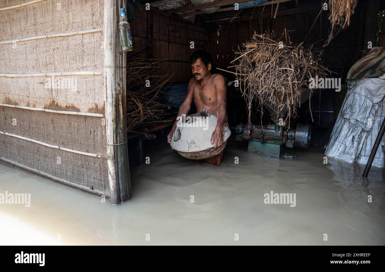 Morigaon, India. 4 July 2024. A person try to save his belongings in ...