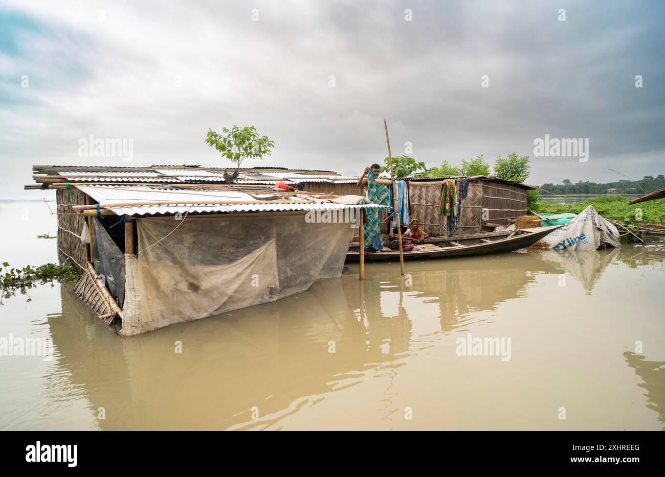Morigaon, India. 4 July 2024. Residents in their flooded house, in a ...