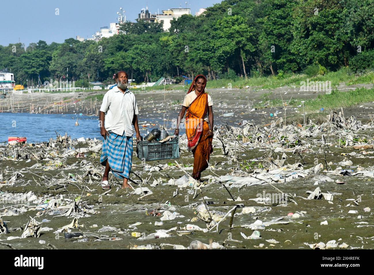 Man and women rag picker collecting plastic bottle and other plastic ...