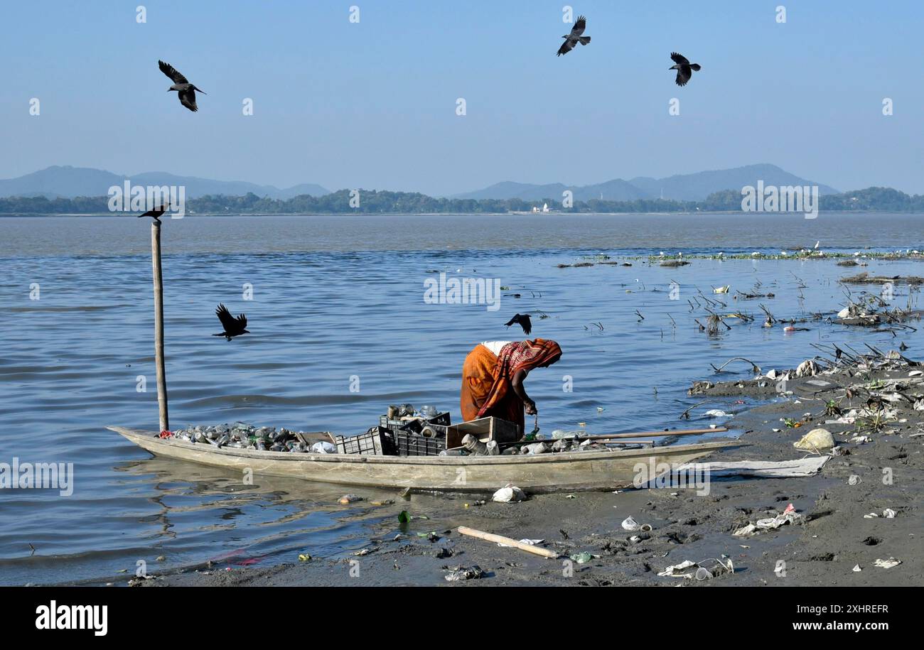 A women rag picker collecting plastic bottle and other plastic ...