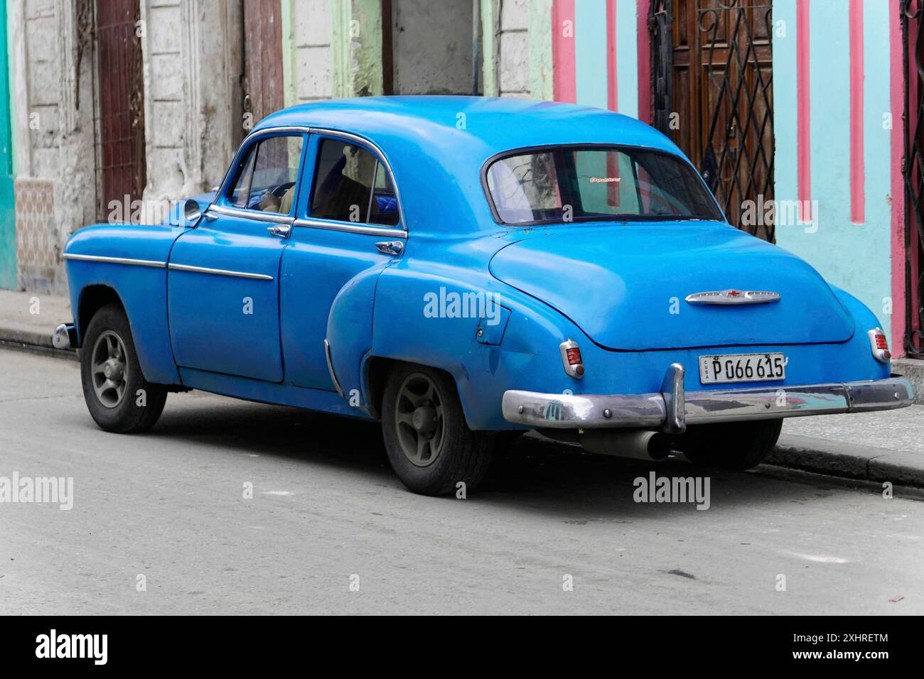 Havana, Cuba, Central America, Blue vintage car parked on a city street ...