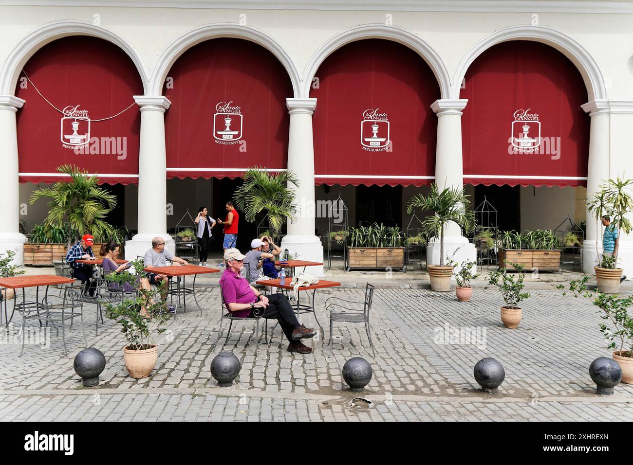 Havana, Cuba, Central America, cafe in a square with red awnings ...
