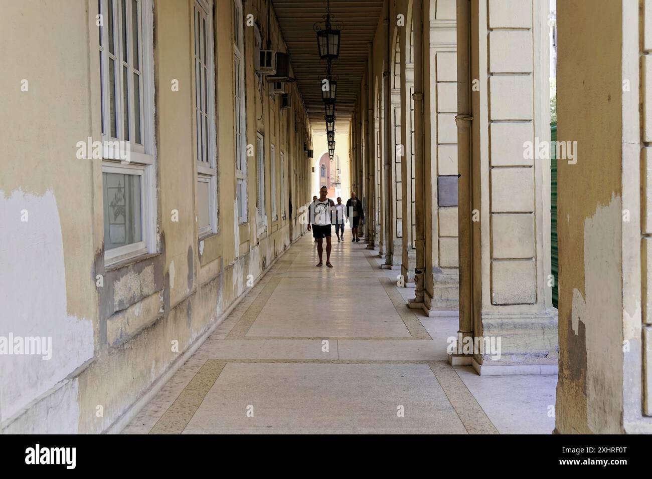 Historical passage with columns and several people walking, Cuba ...