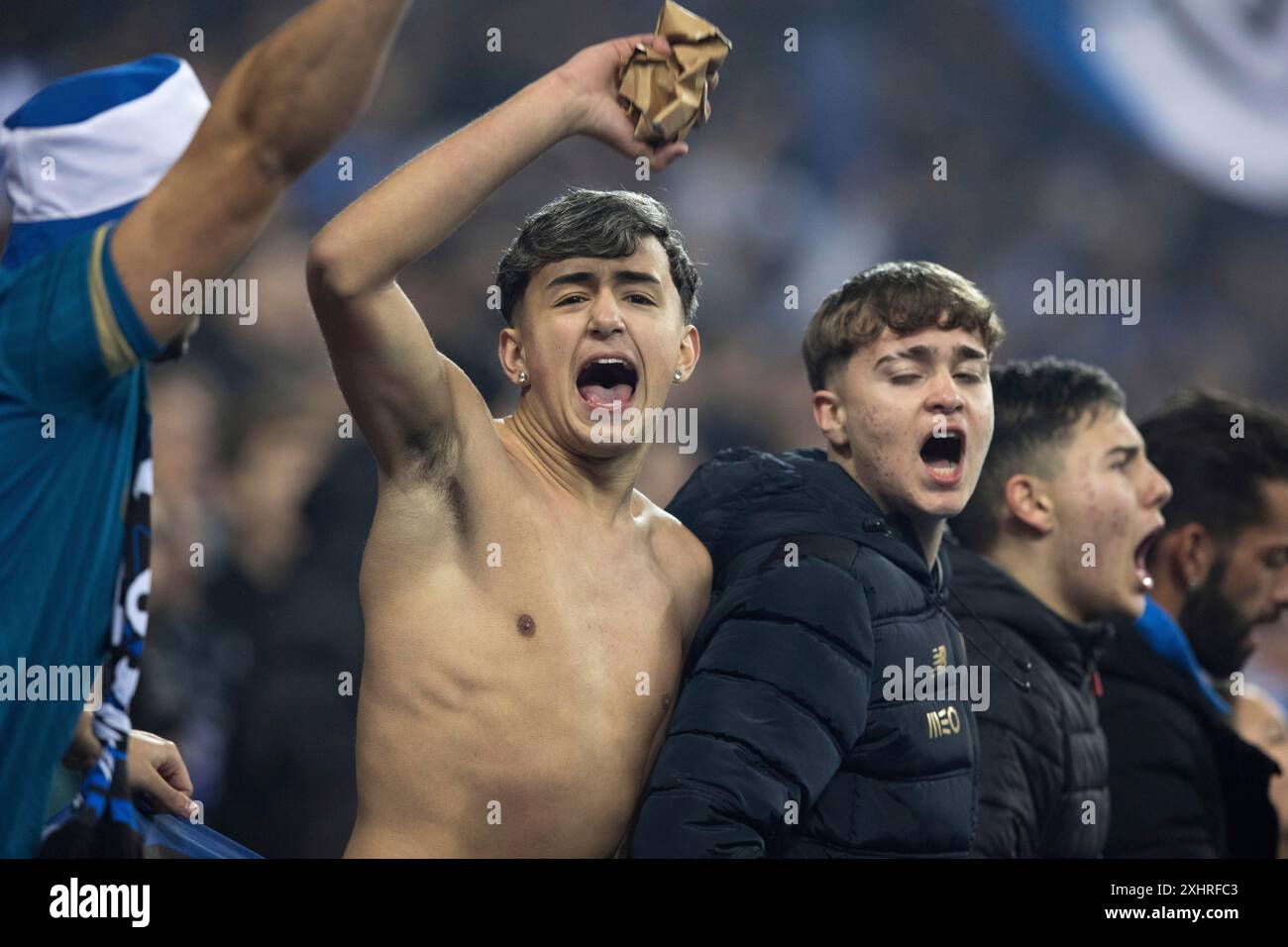 Football match, FC Porto fan on the left cheering with free upper body ...