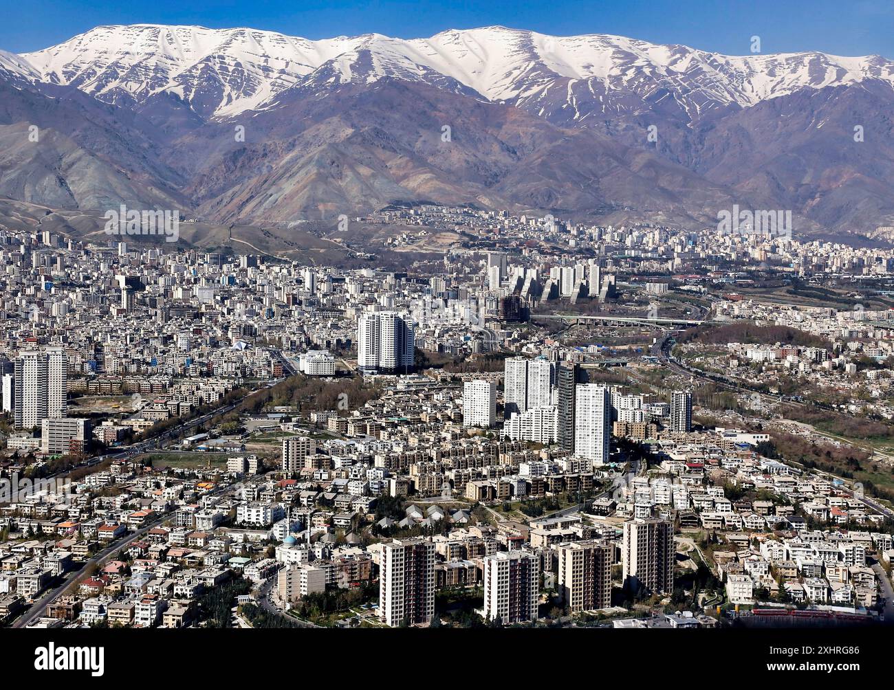 View of the metropolis of Tehran with snow-capped mountains in the ...
