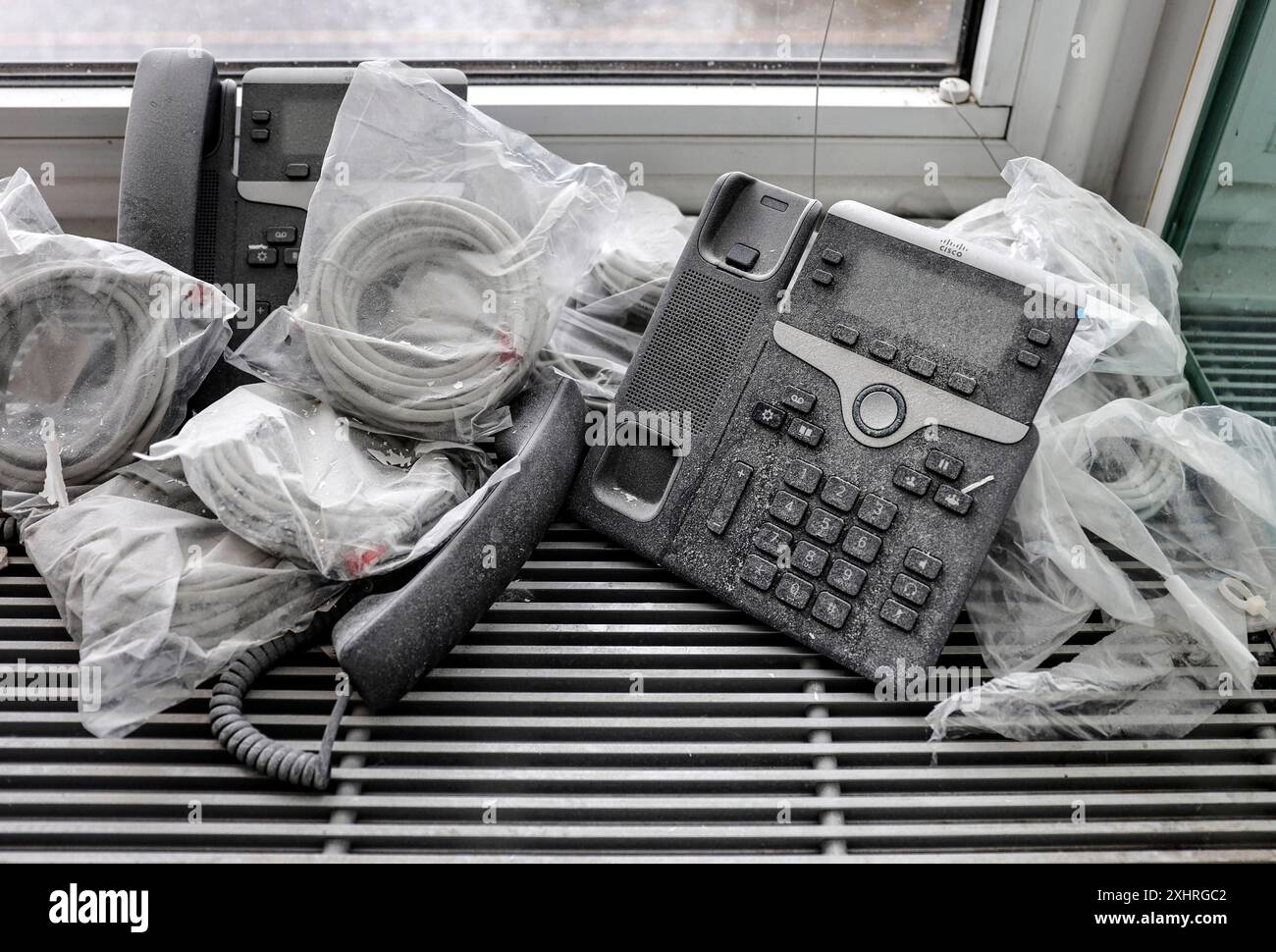 In the construction site of an office lies an old telephone system with ...