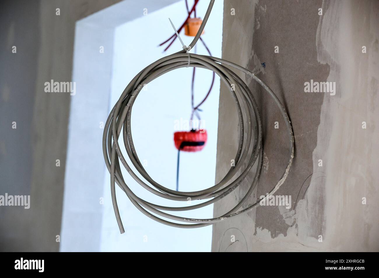 Cables hanging from the ceiling at a construction site, Berlin, 03.07. ...