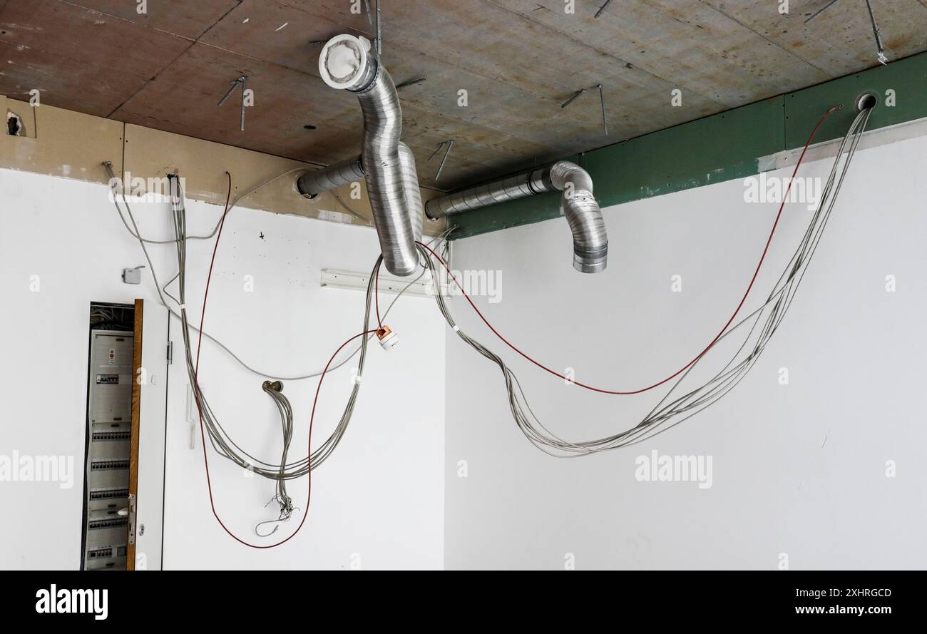 Electrical cables and pipes of a ventilation system on a wall, Berlin ...