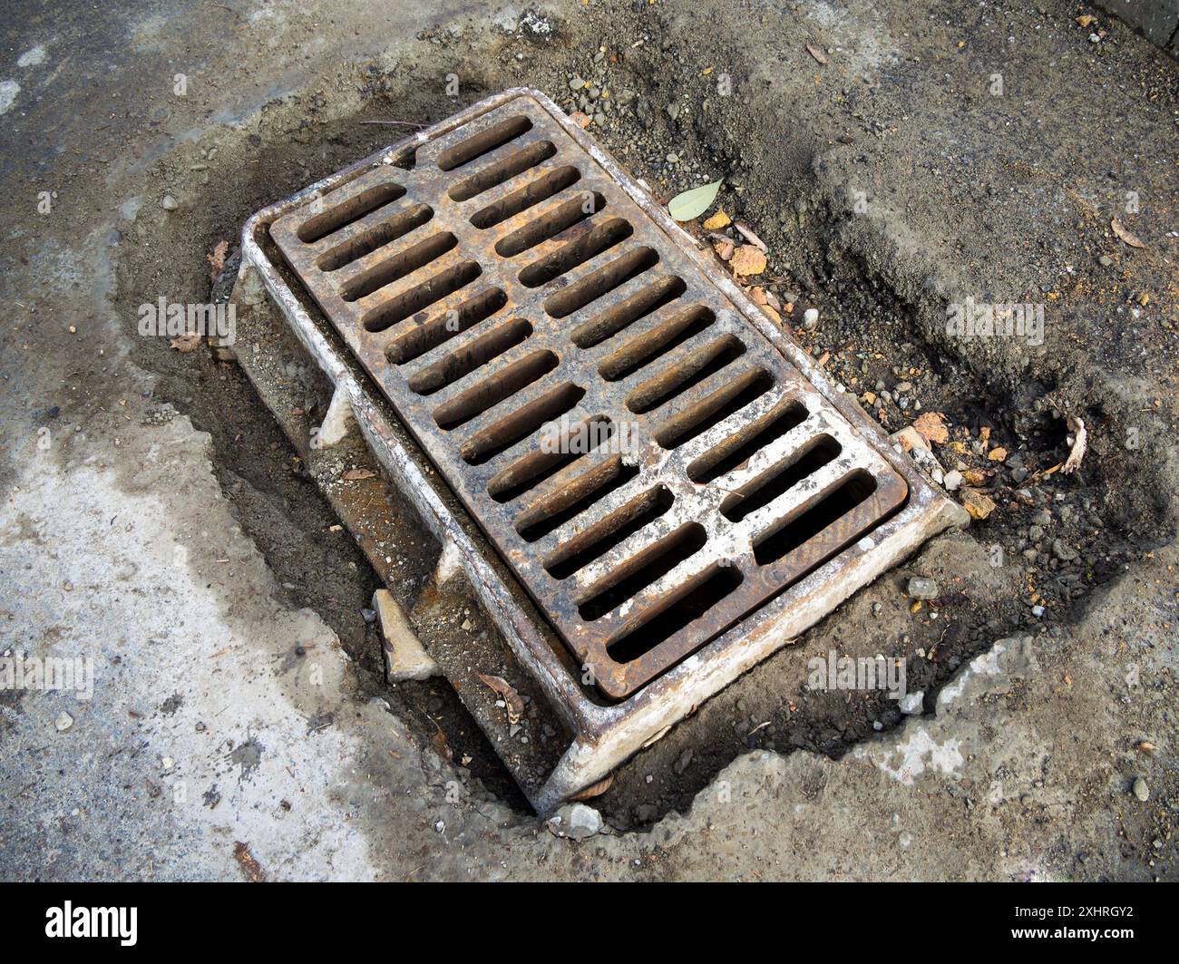 Cast iron storm drain grate on a road being repaired Stock Photo - Alamy