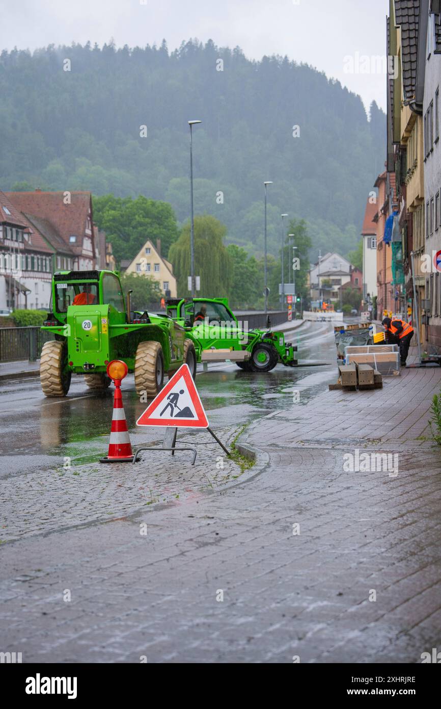 A construction site in a town in the rain, construction workers and ...