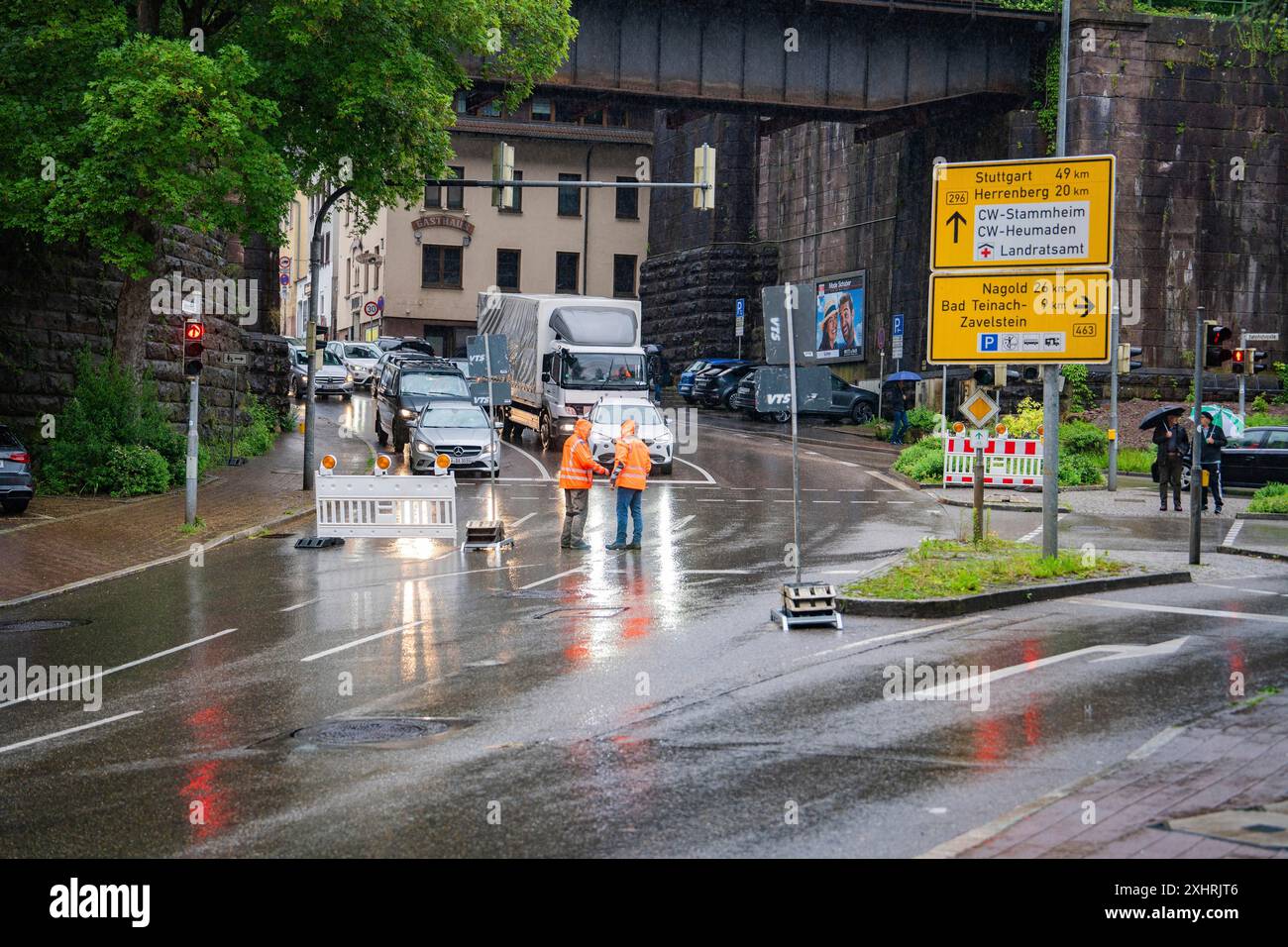 Road closure due to construction site in the city during rain, workers ...