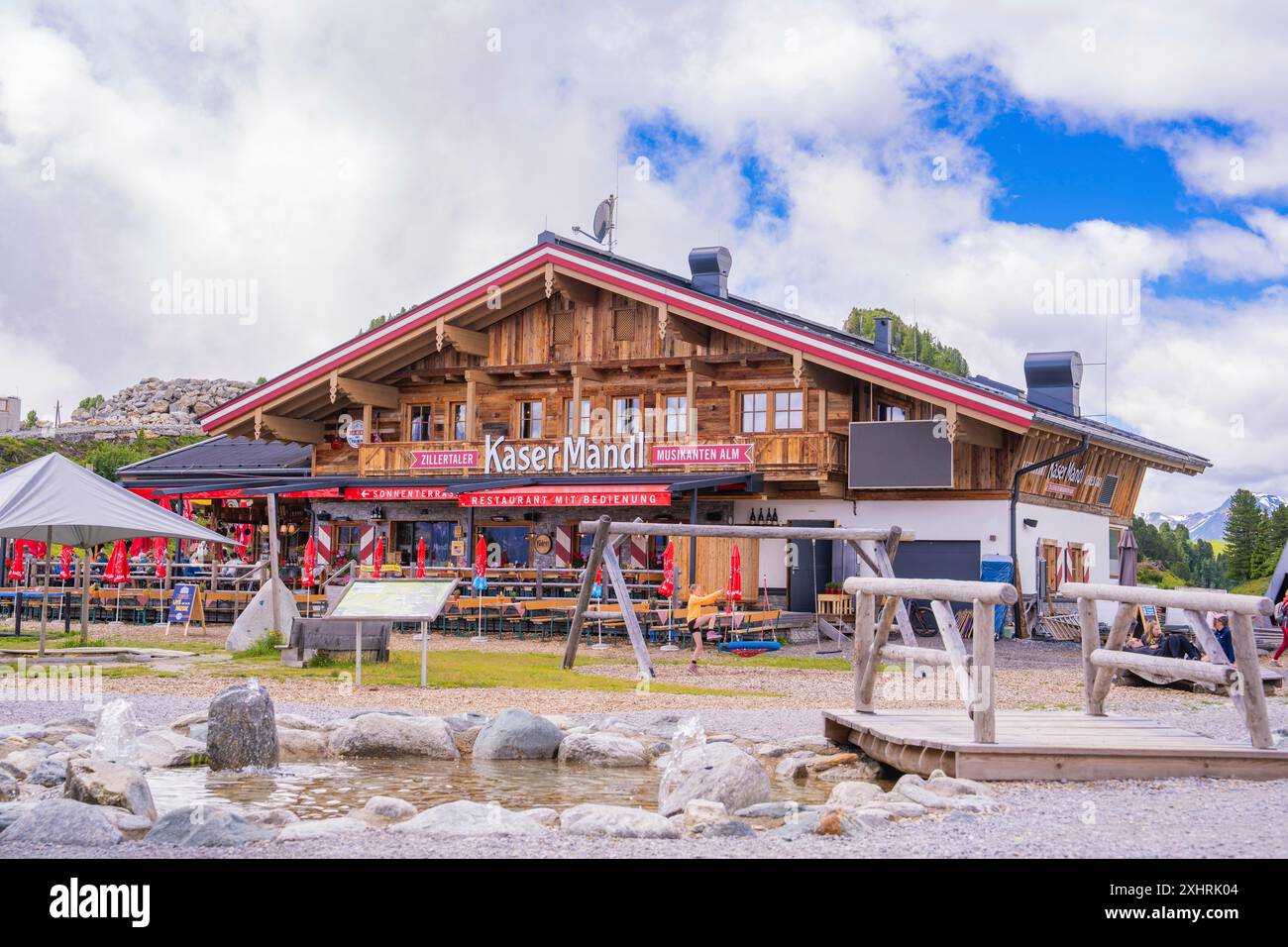 A rustic Alpine restaurant with wooden beams and outdoor seating ...