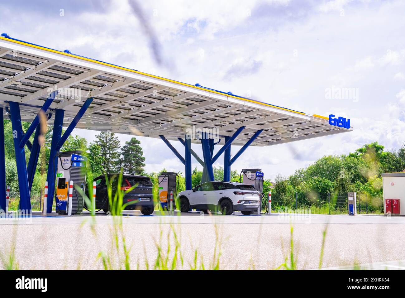 An electric car charging station under a roof with solar modules ...