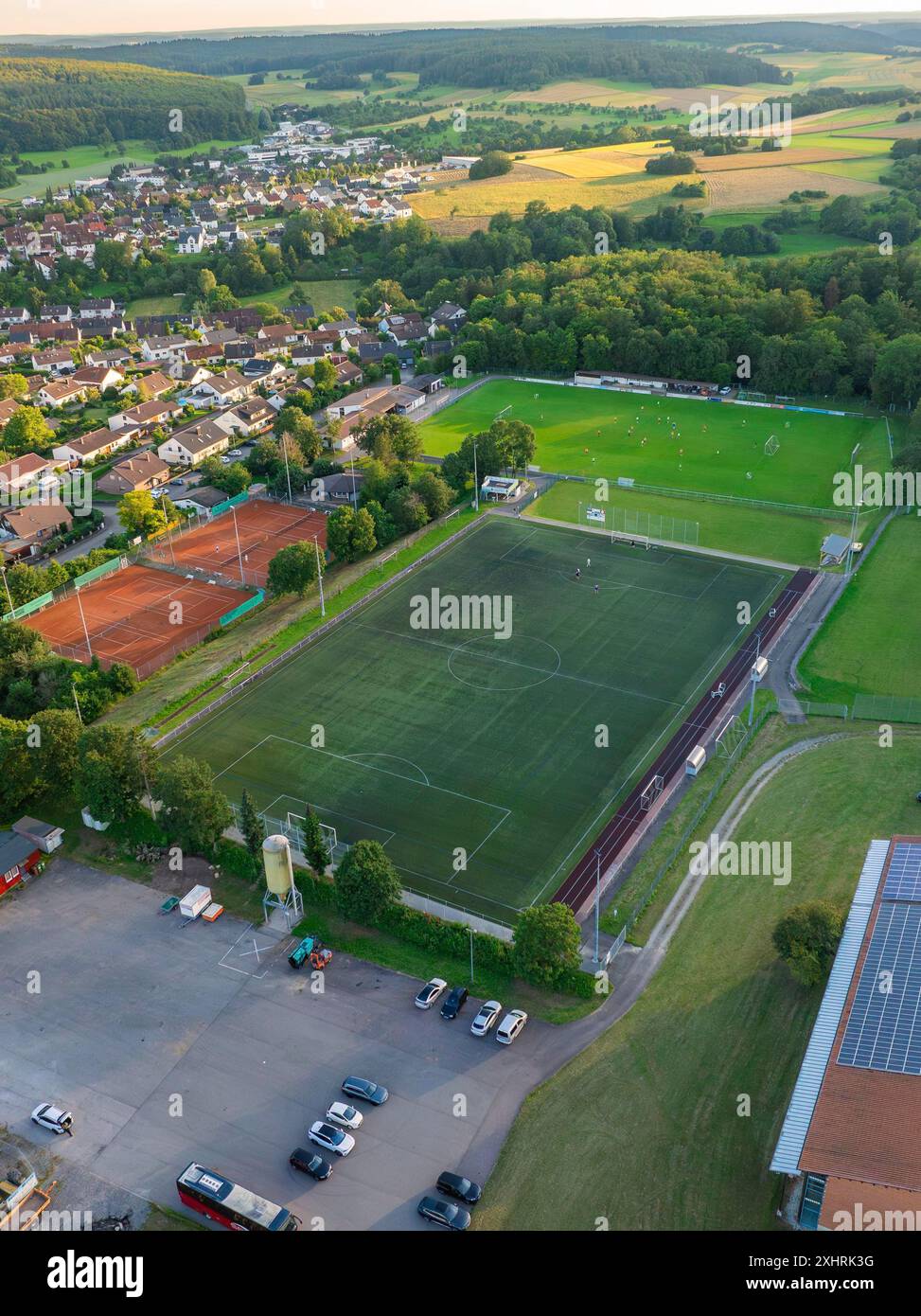 Aerial view of a village with a sports field, football pitches and ...