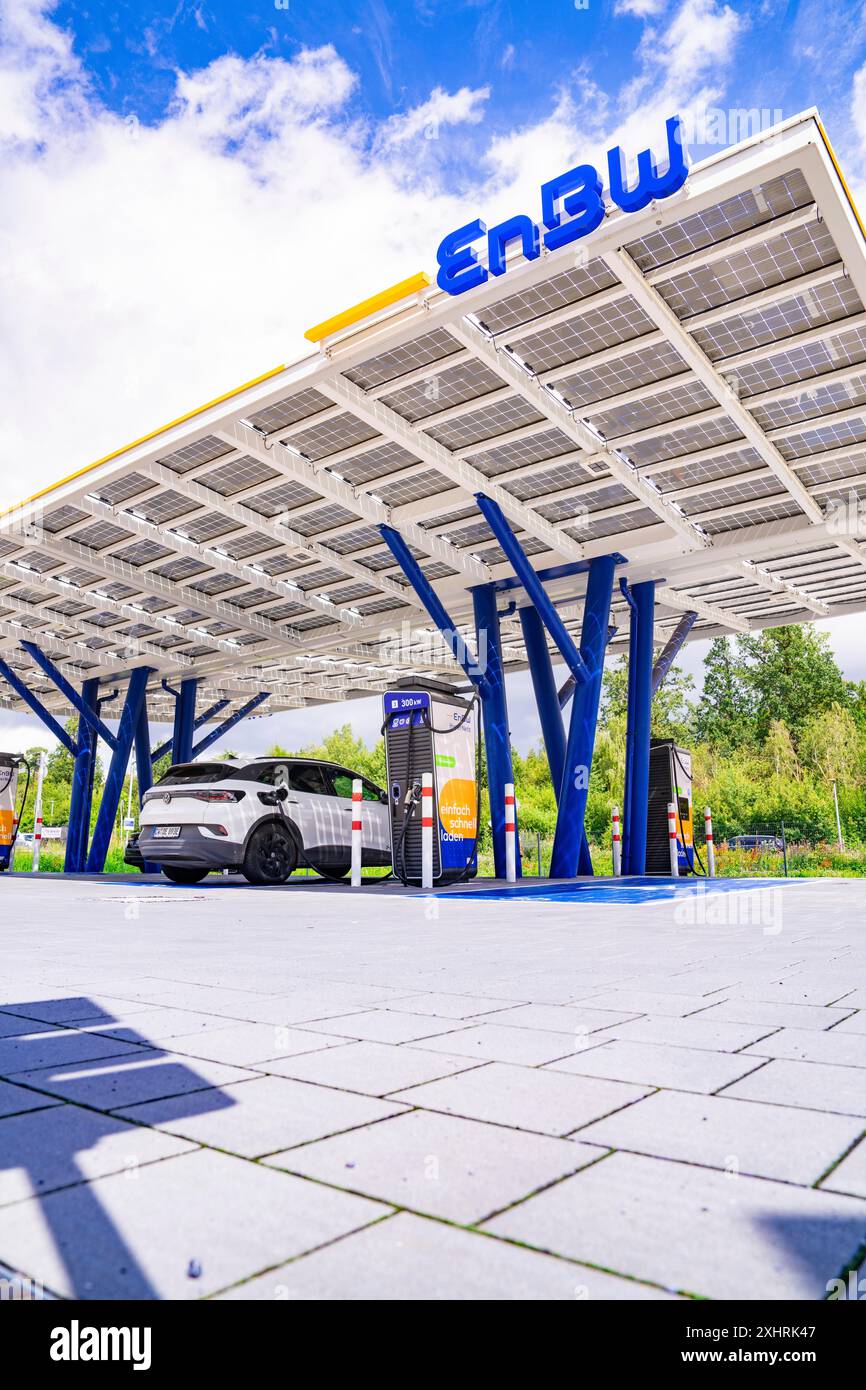 Modern EnBW charging station with solar roof for electric cars in a ...
