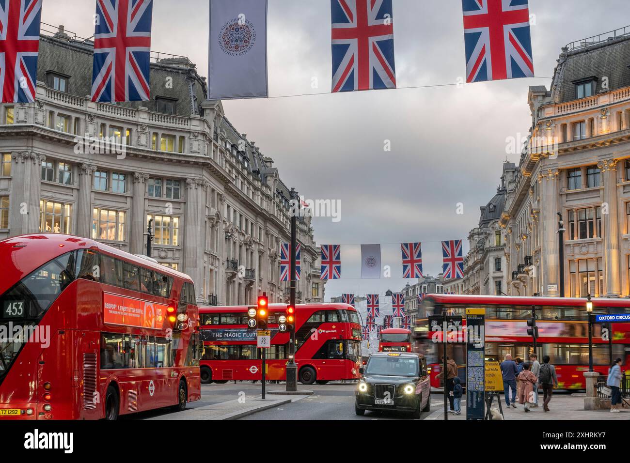 Red double-decker buses, English flags, evening mood, Oxford Circus ...