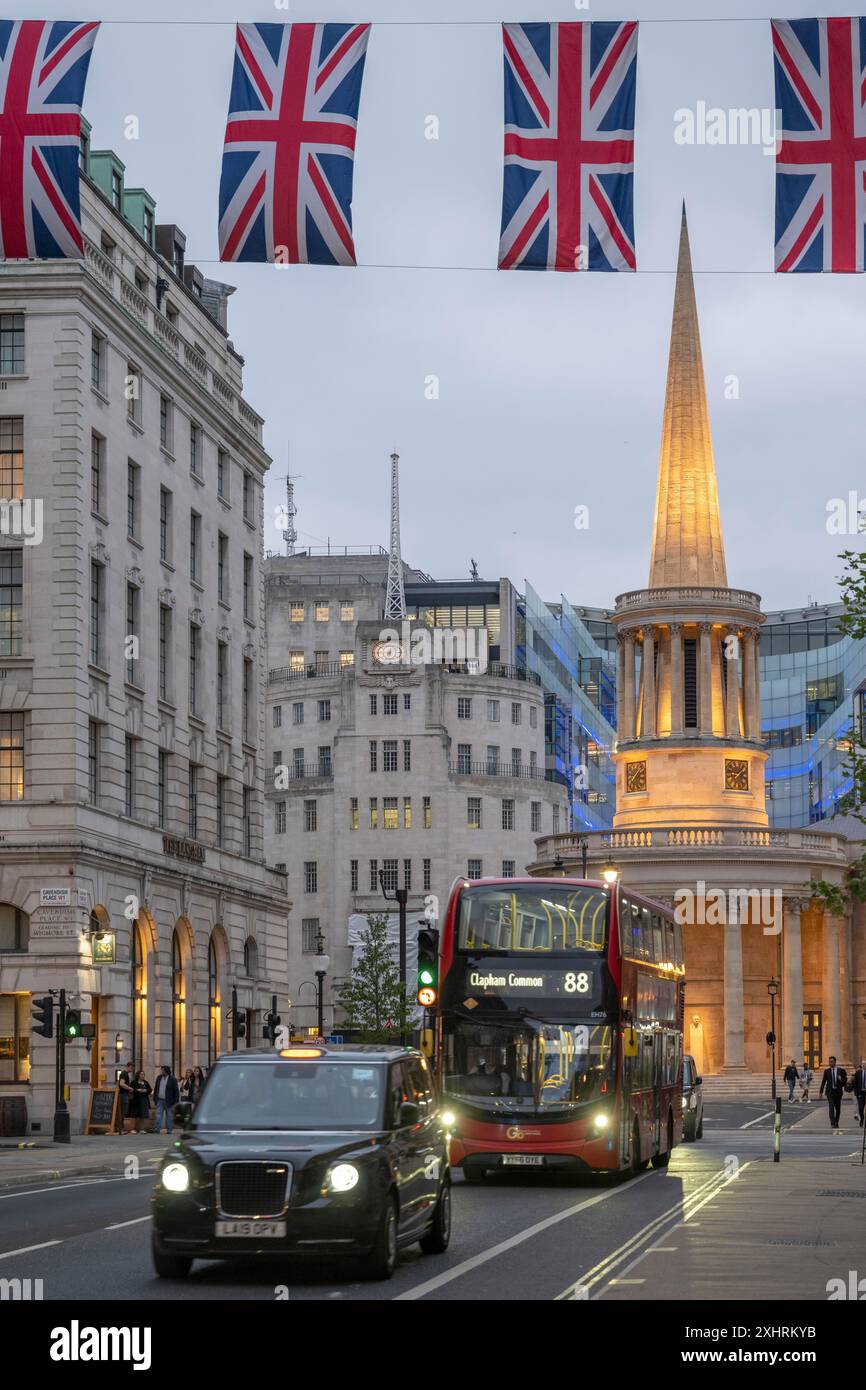 Red double-decker bus and taxi in front of All Souls Langham Place ...