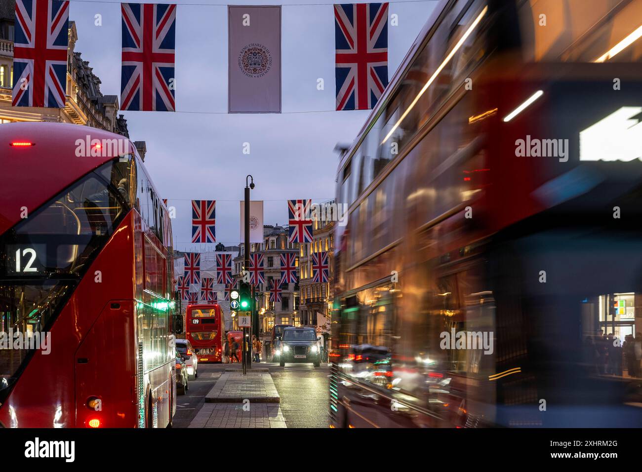 Red double-decker buses, English flags, evening mood, Oxford Circus ...