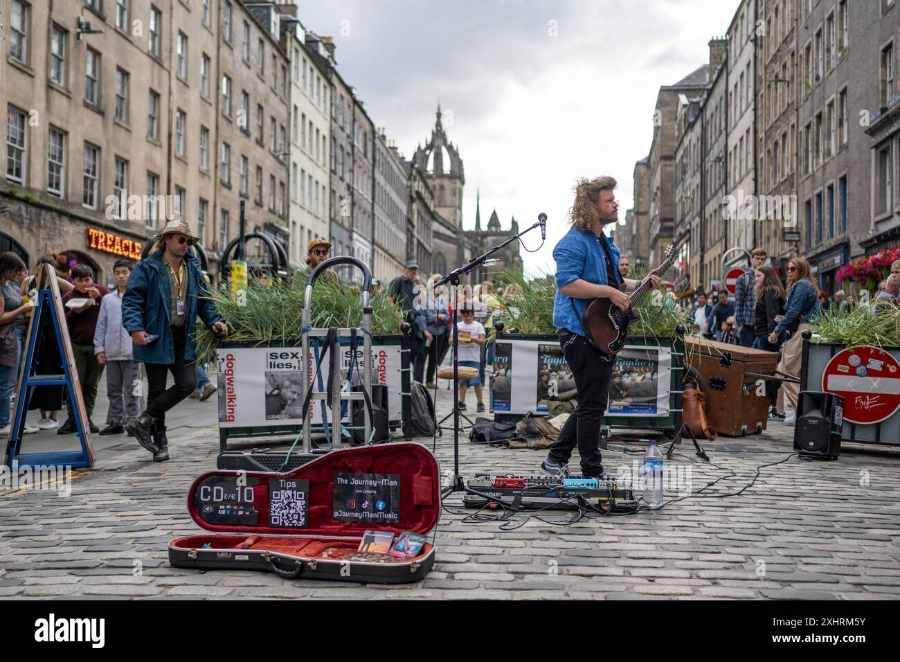 Street musician with electric guitar surrounded by spectators, world's ...