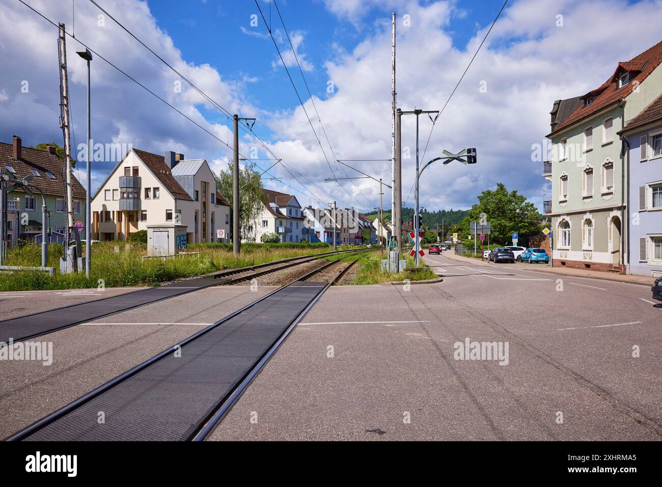Road and railway line with gated level crossing in Gengenbach, Black ...