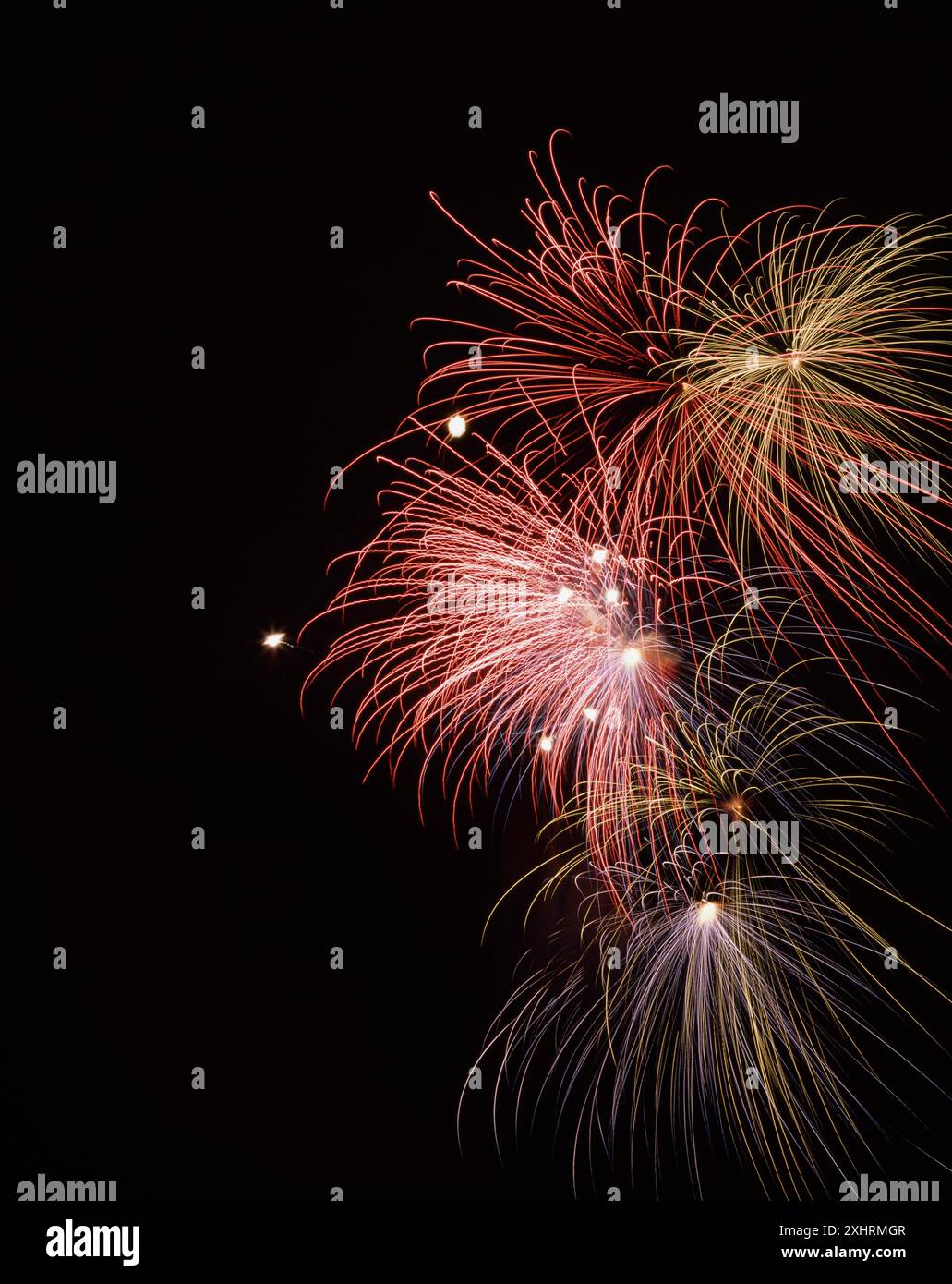 Red, blue and yellow fireworks bursts in night sky, Montreal ...