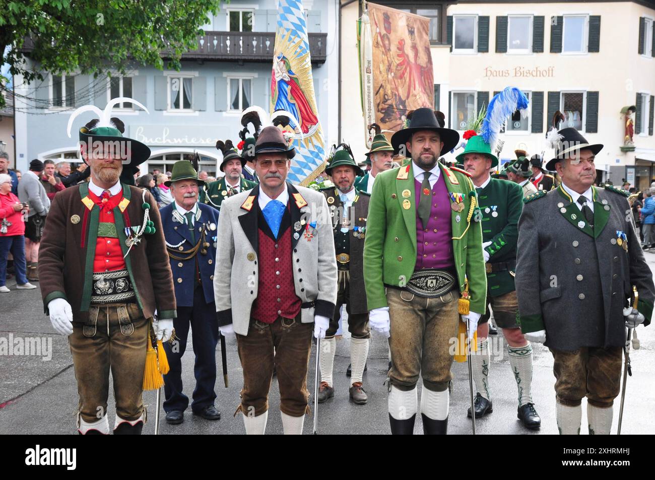 Men in traditional Bavarian traditional costume stand on a village ...