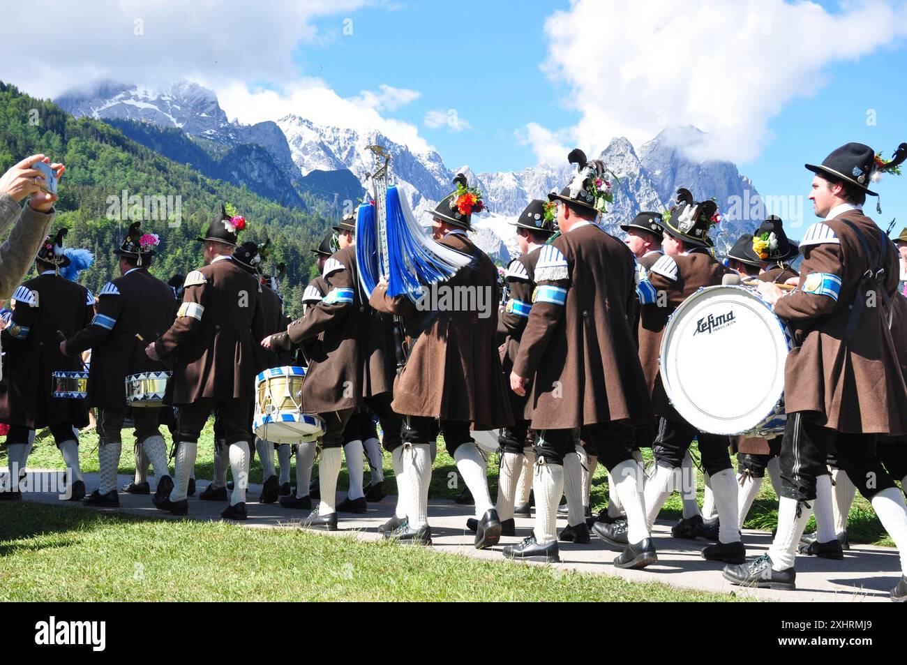 Musicians in traditional dress with drums and other instruments march ...