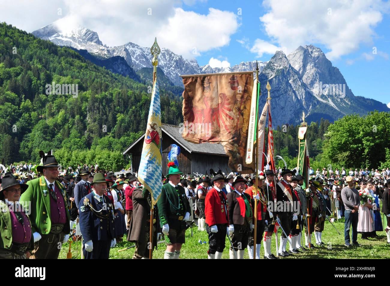Groups of people in traditional costumes and with flags during a ...