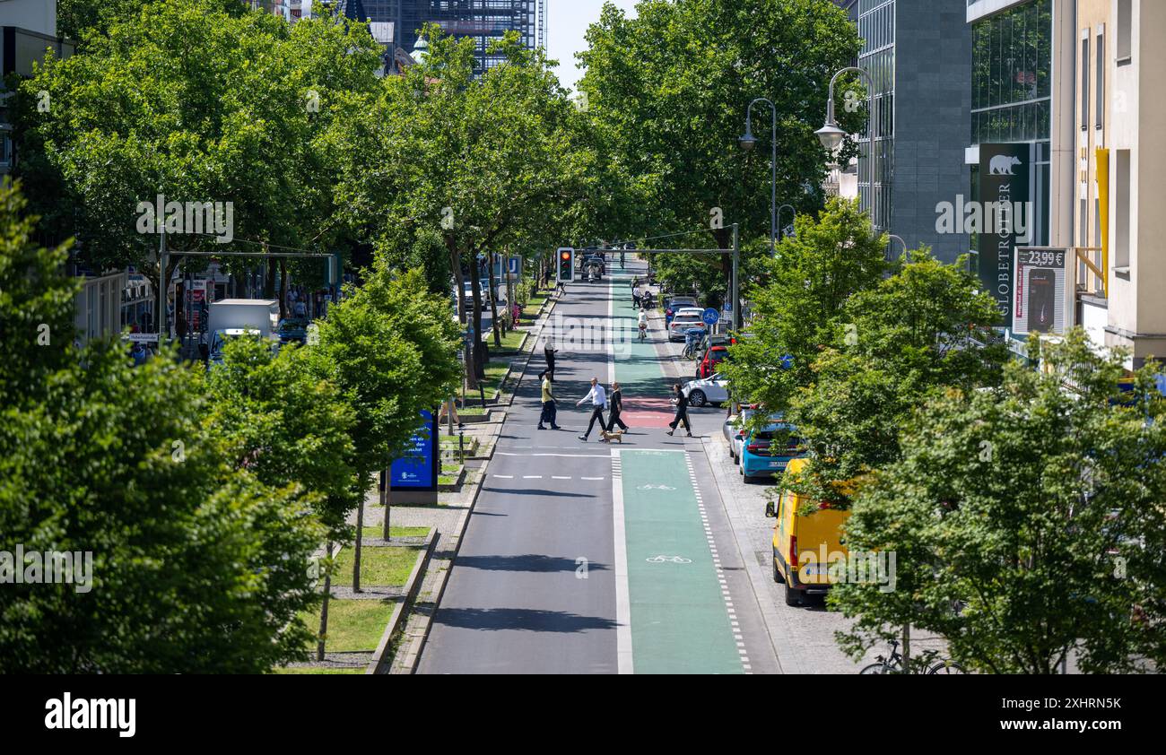 Berlin, Germany. 15th July, 2024. Passers-by cross Schloßstraße, a well ...