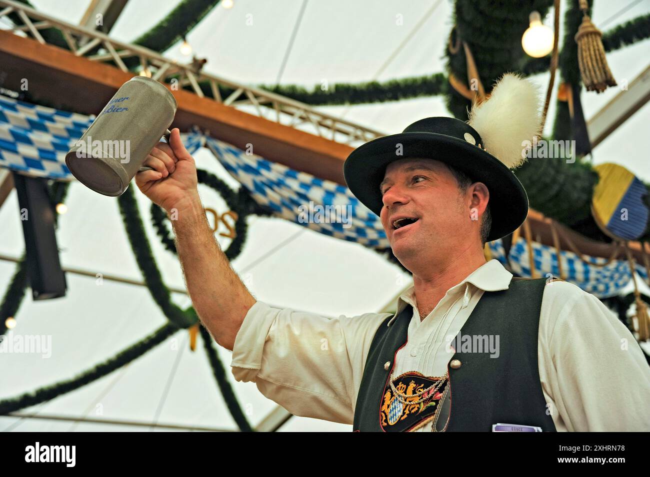 Bandleader of a brass band, man in traditional Bavarian traditional ...