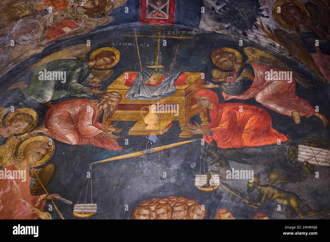 Medieval fresco depicting angels and saints kneeling in front of a ...