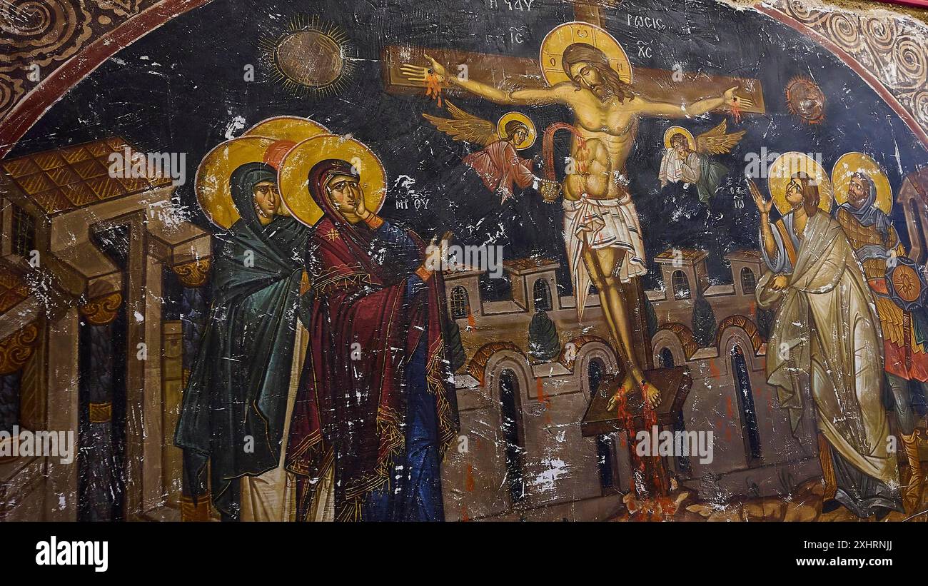 Medieval fresco of the crucifixion of Jesus with Mary, disciples and angels. Emotionally charged ...