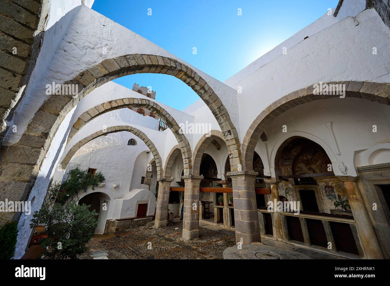Inner courtyard of a historic monastery with stone arcades and white ...