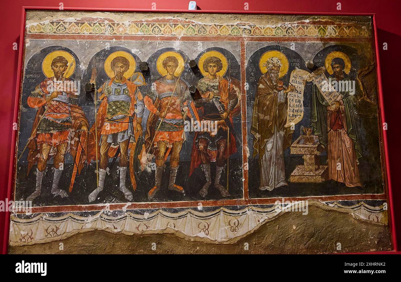 Medieval fresco depicting saints and apostles, all with glowing halos ...
