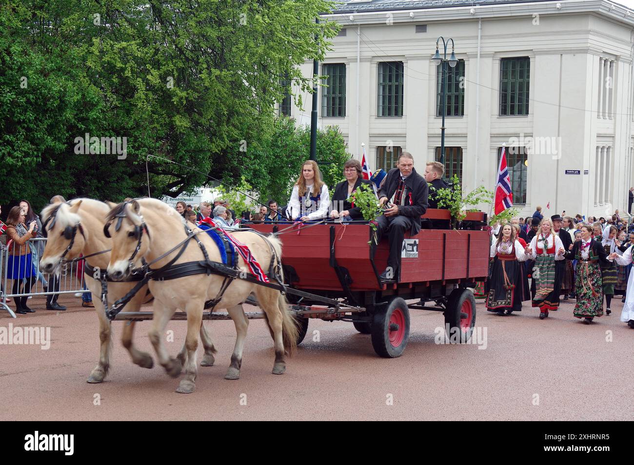 Horse-drawn carriage with traditionally dressed people at a Norwegian ...