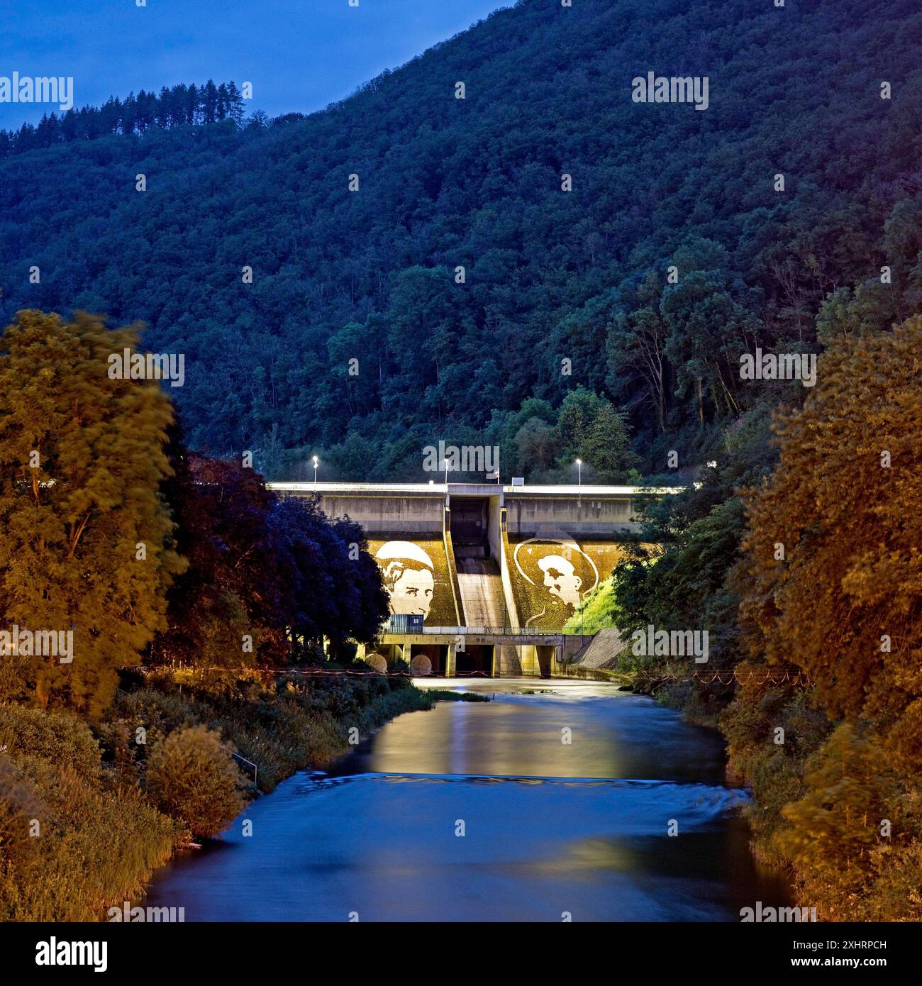 The dammed river Our with art on the illuminated dam wall of the lower ...
