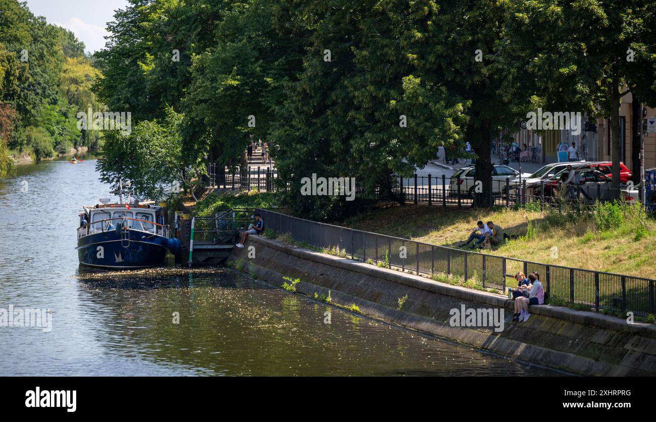 Berlin, Germany. 15th July, 2024. People sit on the Maybachufer on the ...