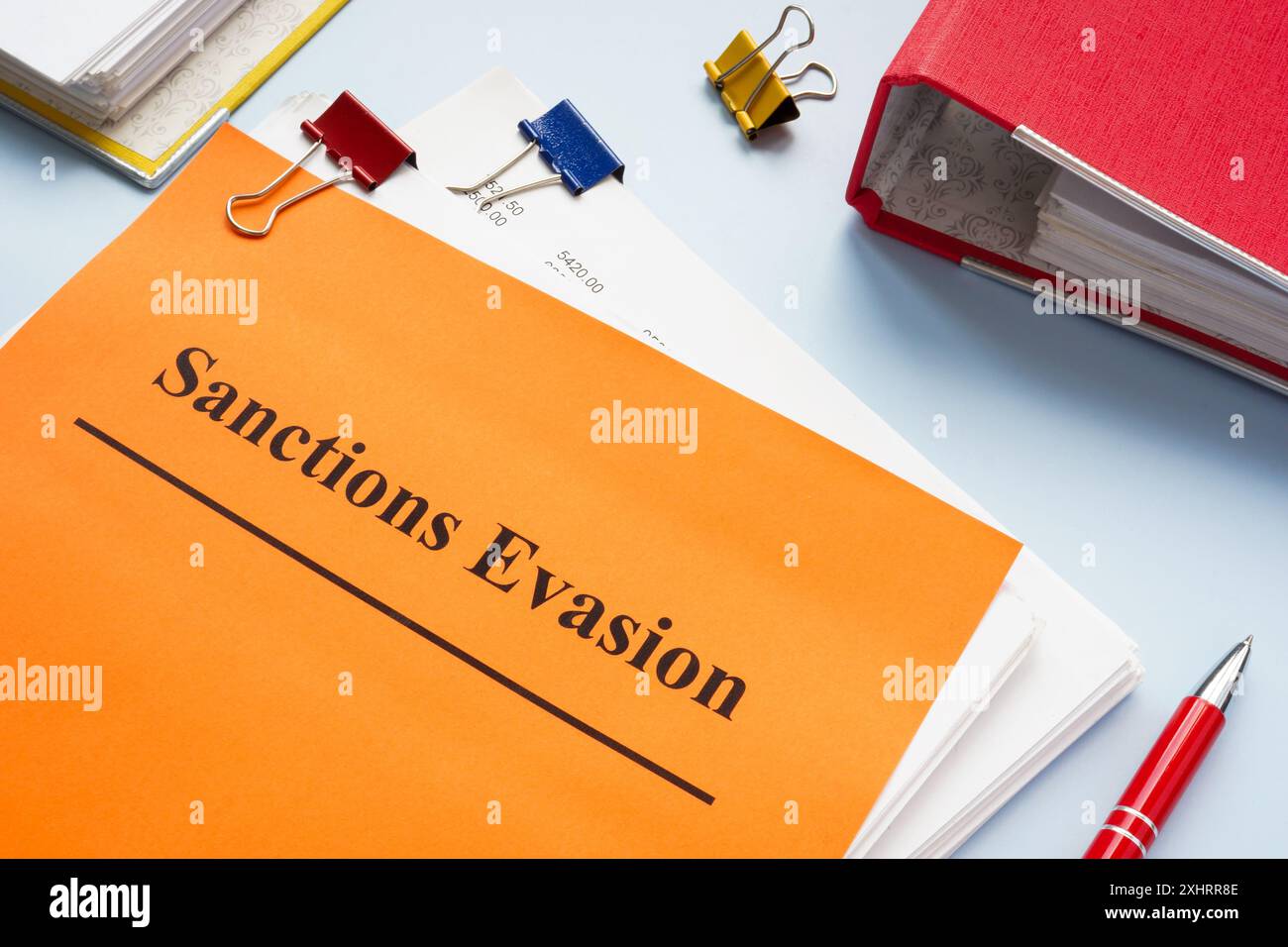 Stack of papers with report about sanctions evasion Stock Photo - Alamy