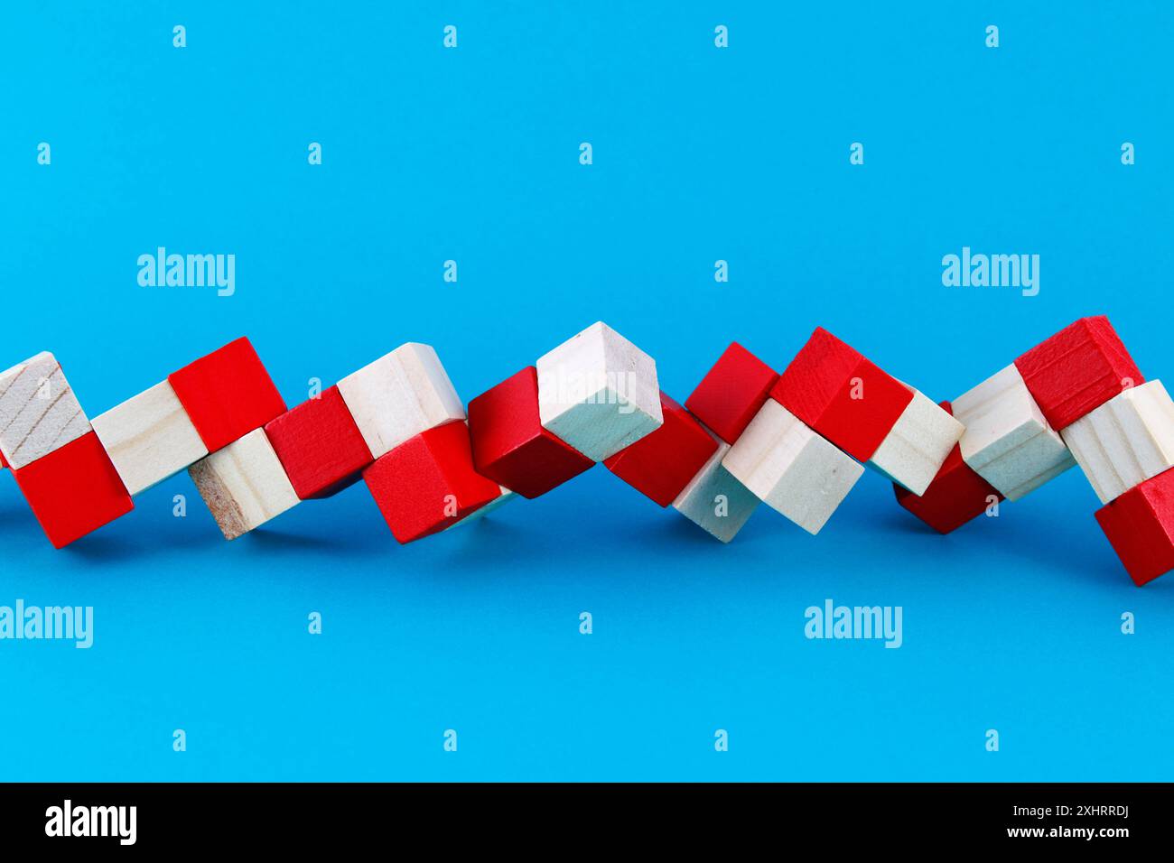 Wooden cubes connected to each other forming a messy row Stock Photo ...