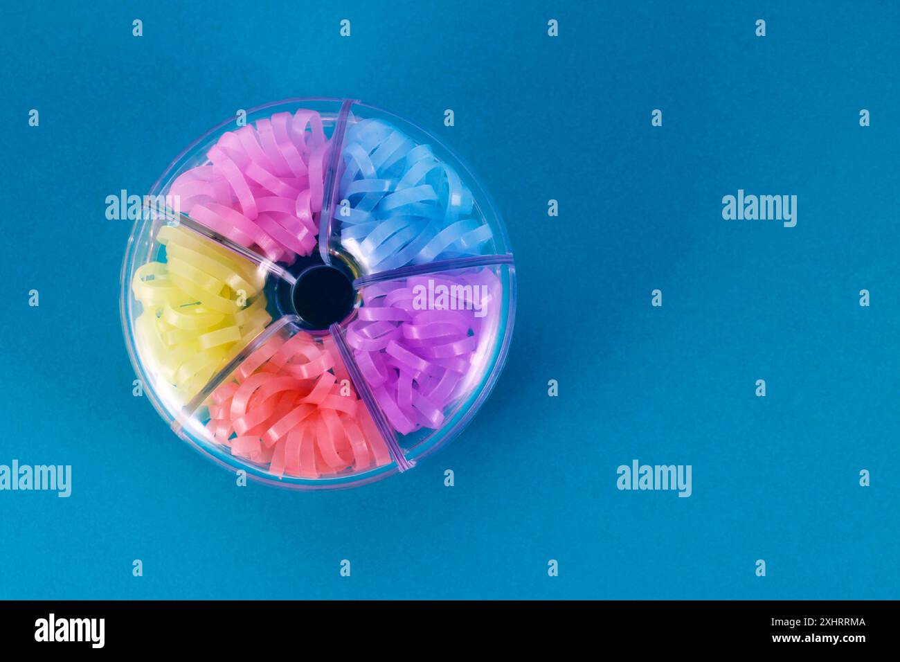 Donut shaped container with colorful rubber bands Stock Photo - Alamy