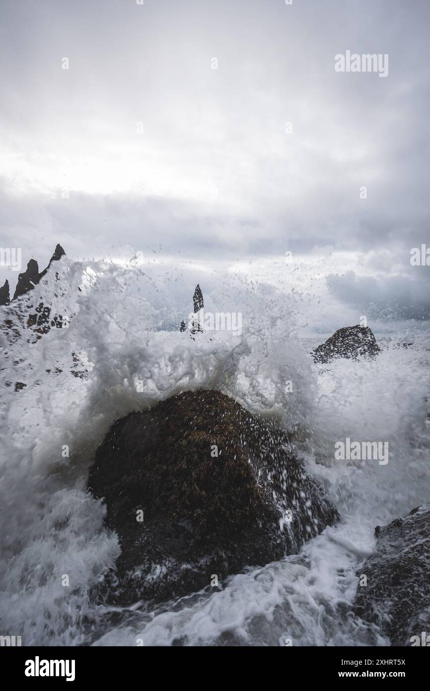 View from within a cave at Reynisfjara black sand beach in Iceland ...