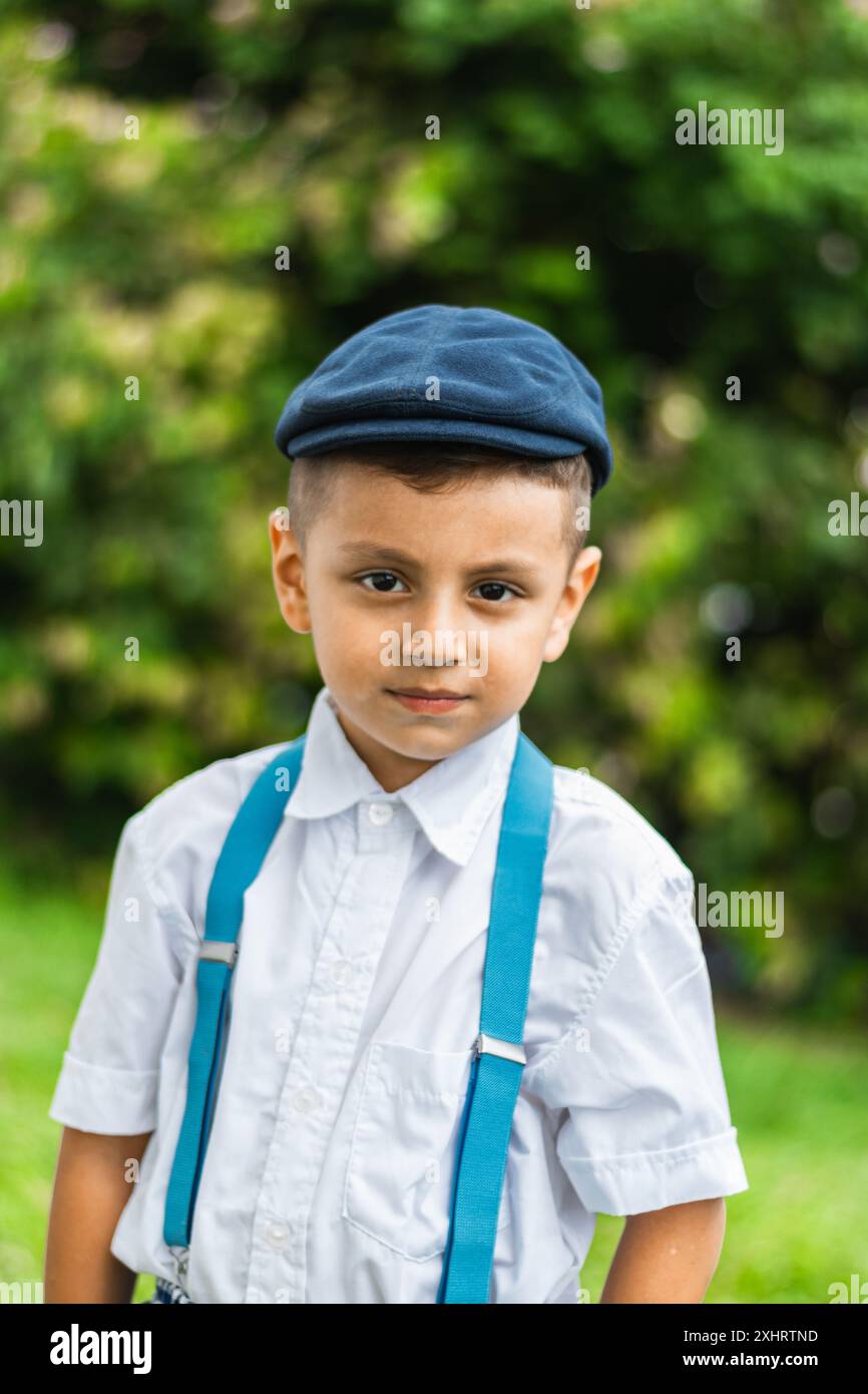 portrait of small latin boy looking straight ahead with a slight smile ...
