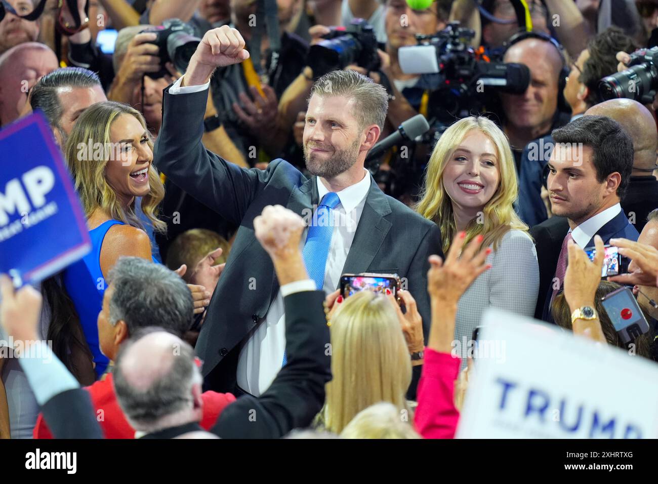 Eric Trump, center, raises his arm during roll call of the states ...