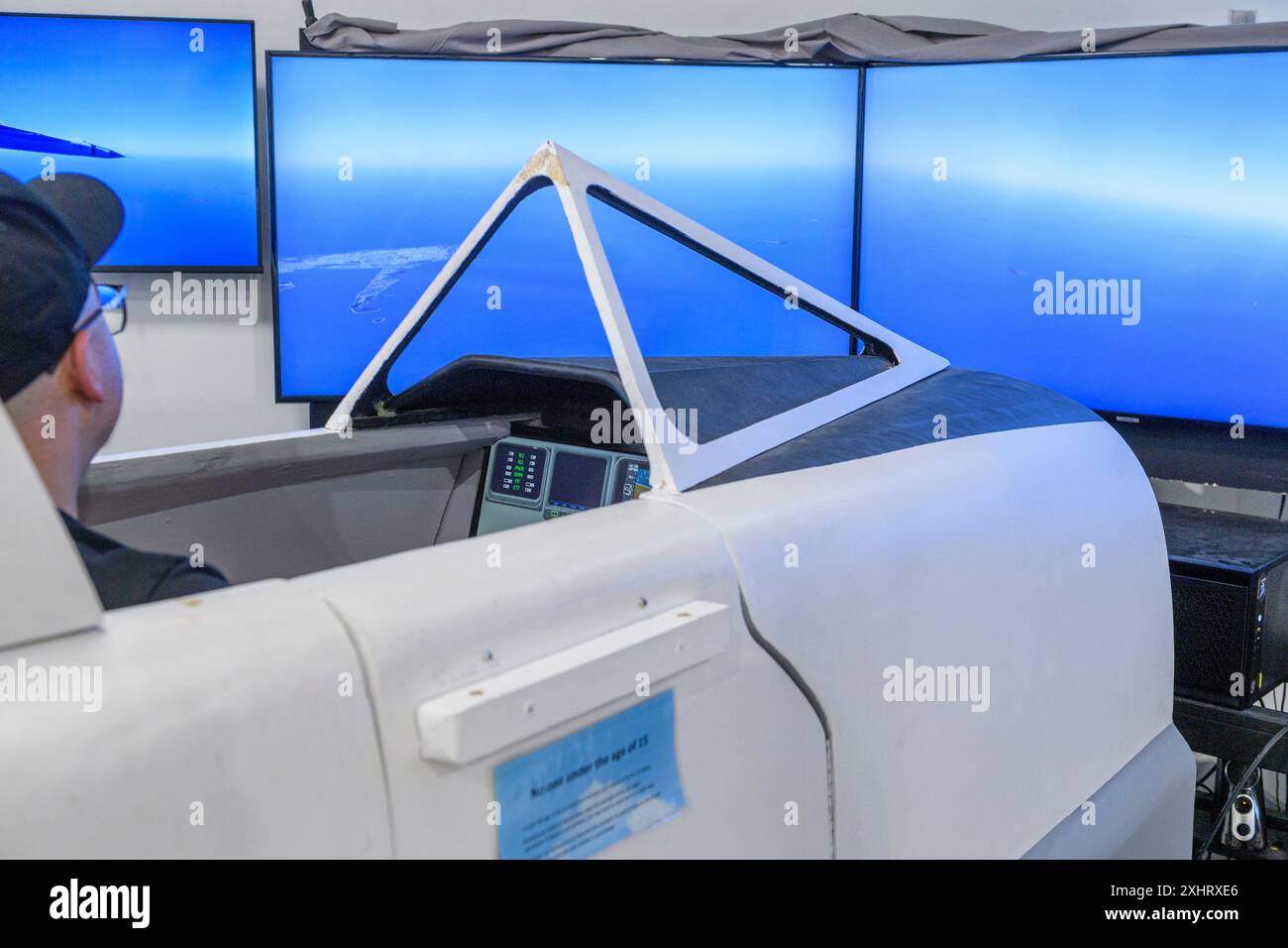 Flight simulator with panoramic screens showing a simulated flight ...