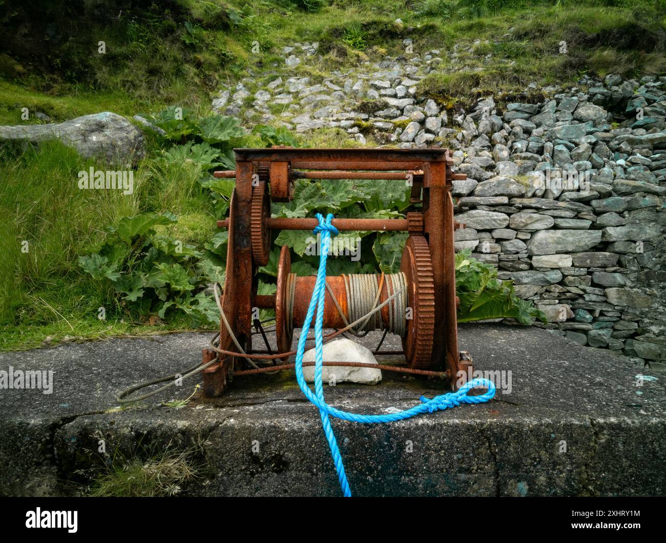 An old, unused rusty winch on the quay at Kildavnet on Atlantic Drive ...