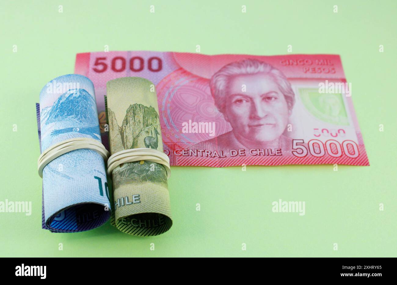 5000 Chilean pesos along with rolls of other banknotes Stock Photo - Alamy