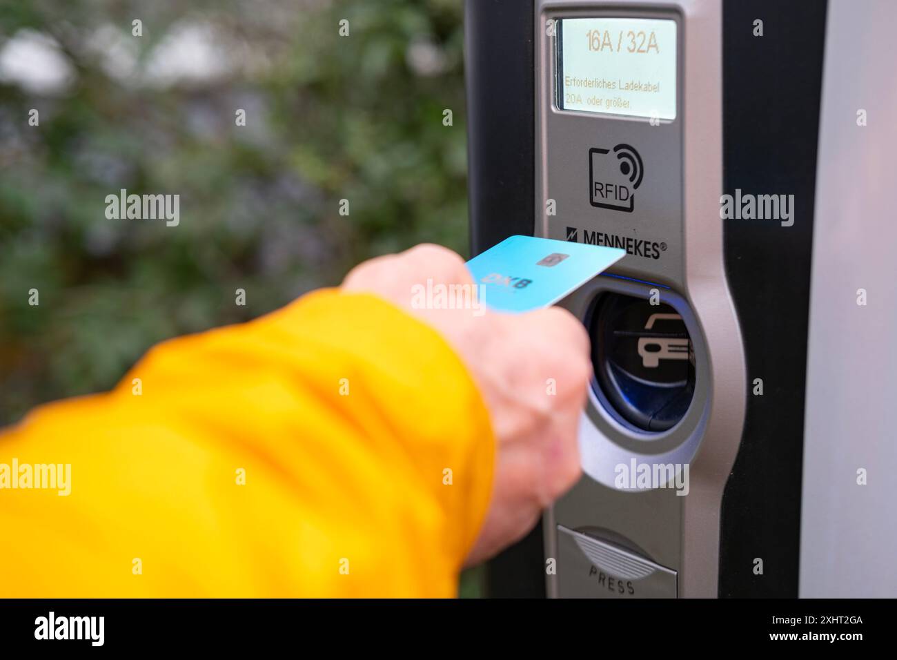 close-up man holding bank card to pay for LG Energy Solution charging ...
