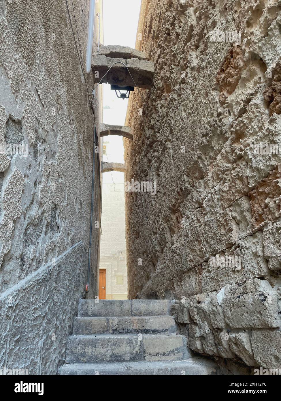 Tight alleyway between the walls of buildings in the historical center ...